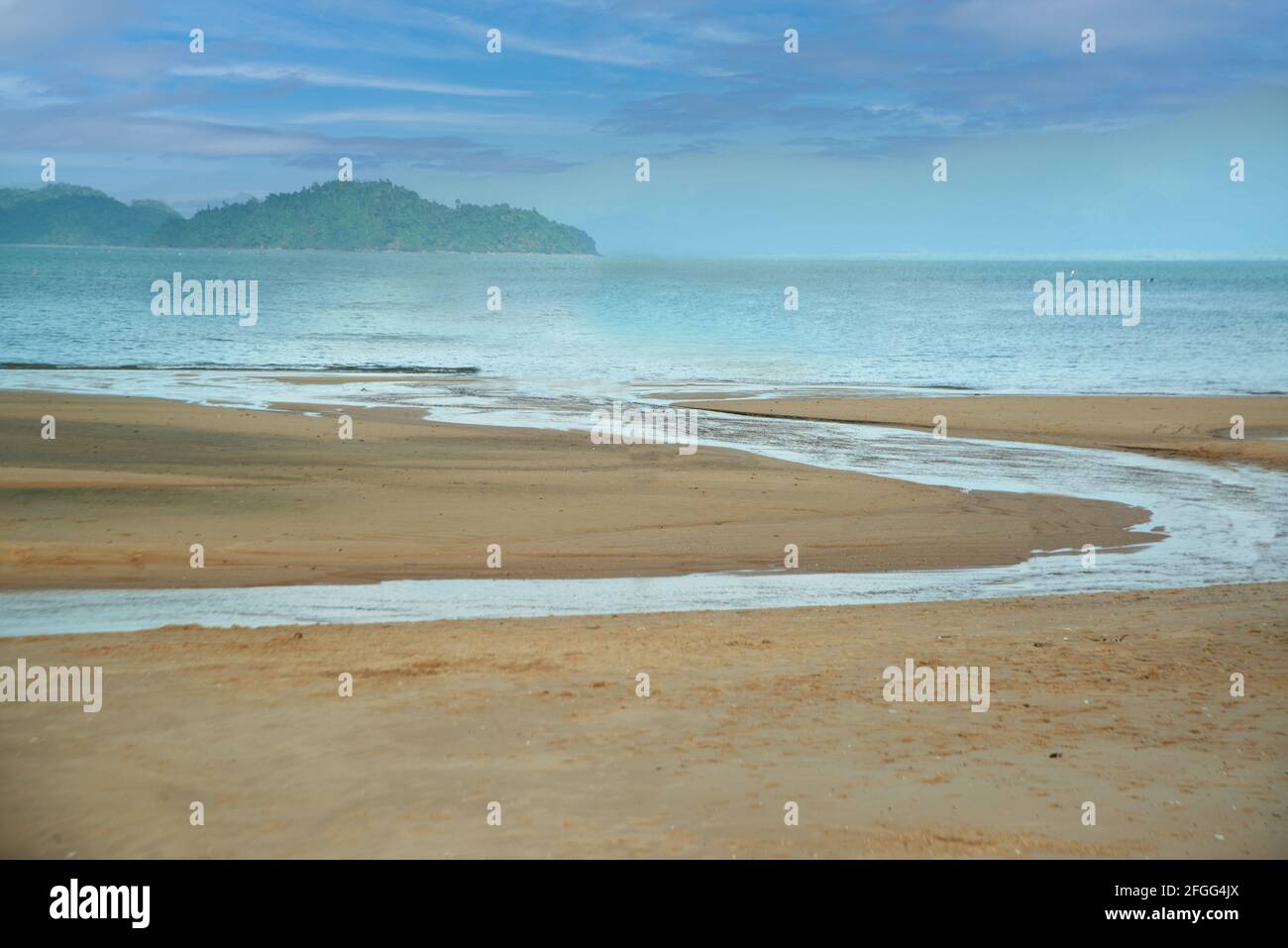 Waves from the receding tide lap the sand at Koh Phrayam island in ...