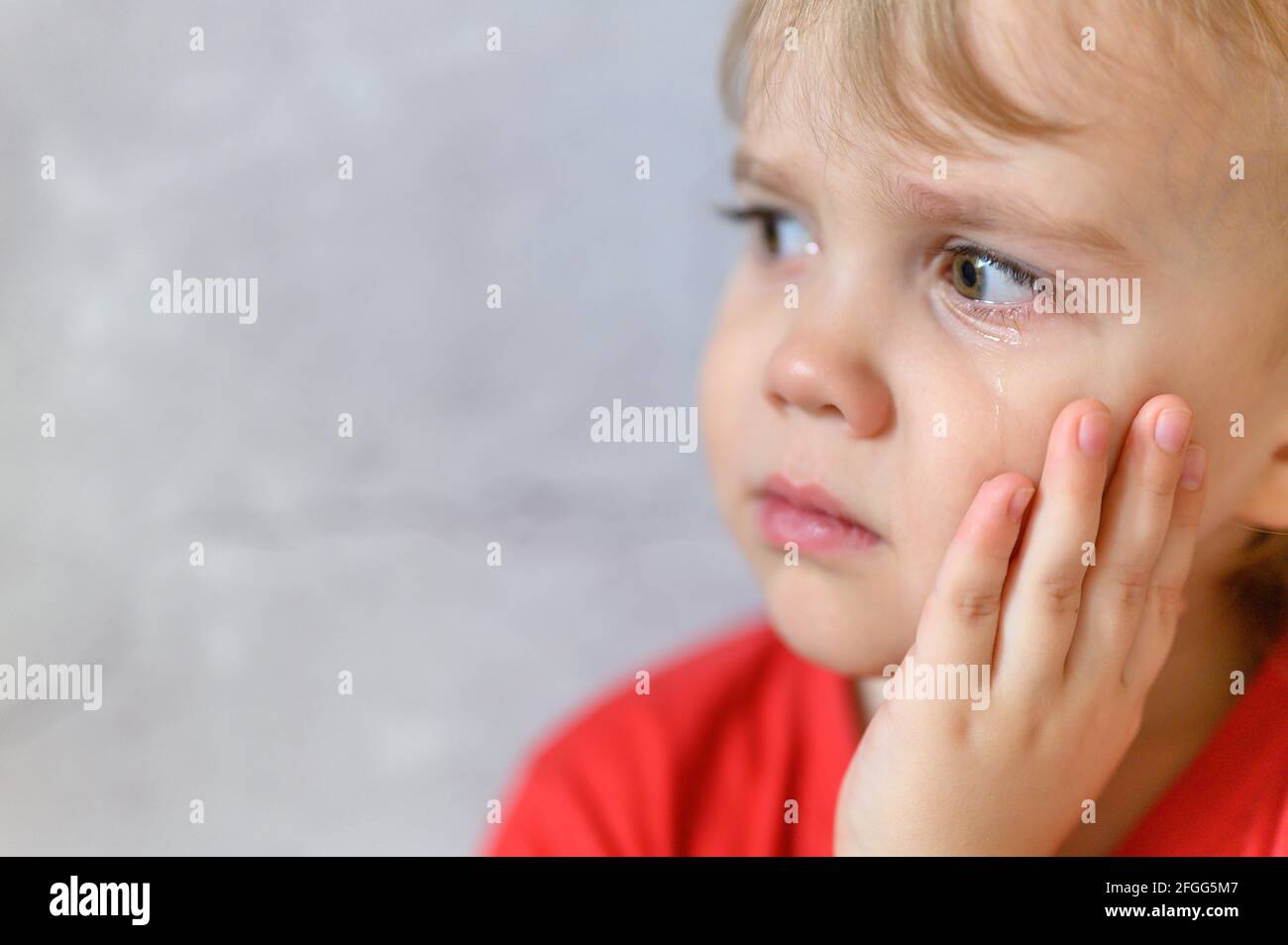 kid crying. the face of a cute little upset four year old baby boy in ...
