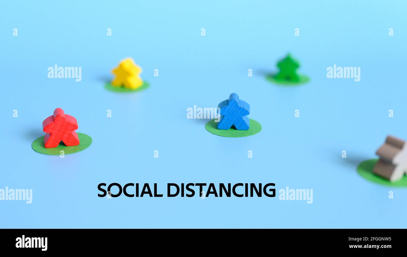 several multicolored small wooden figures of people stand at a distance ...