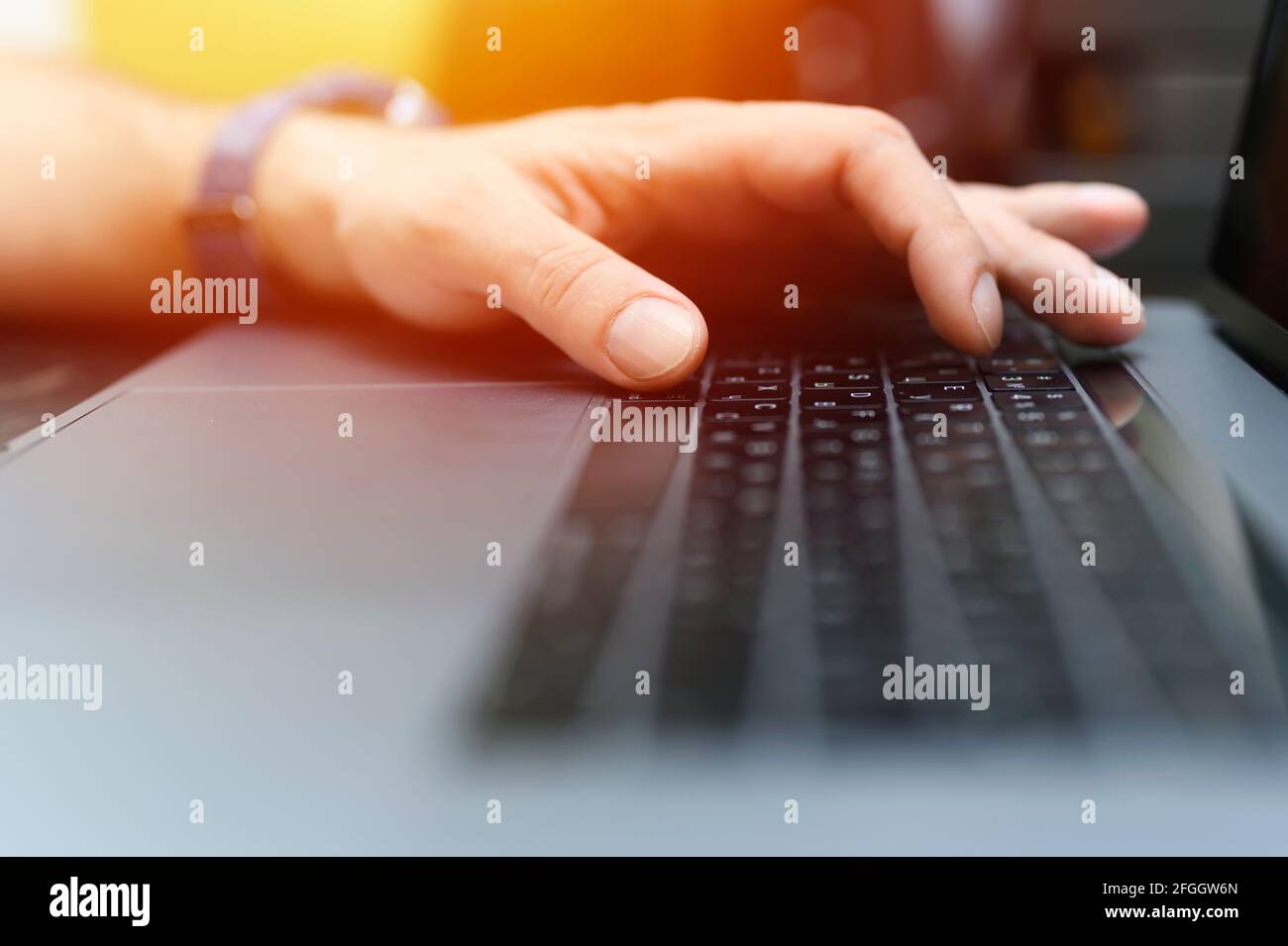 male hand typing on the keyboard a laptop. working man programmer. work ...
