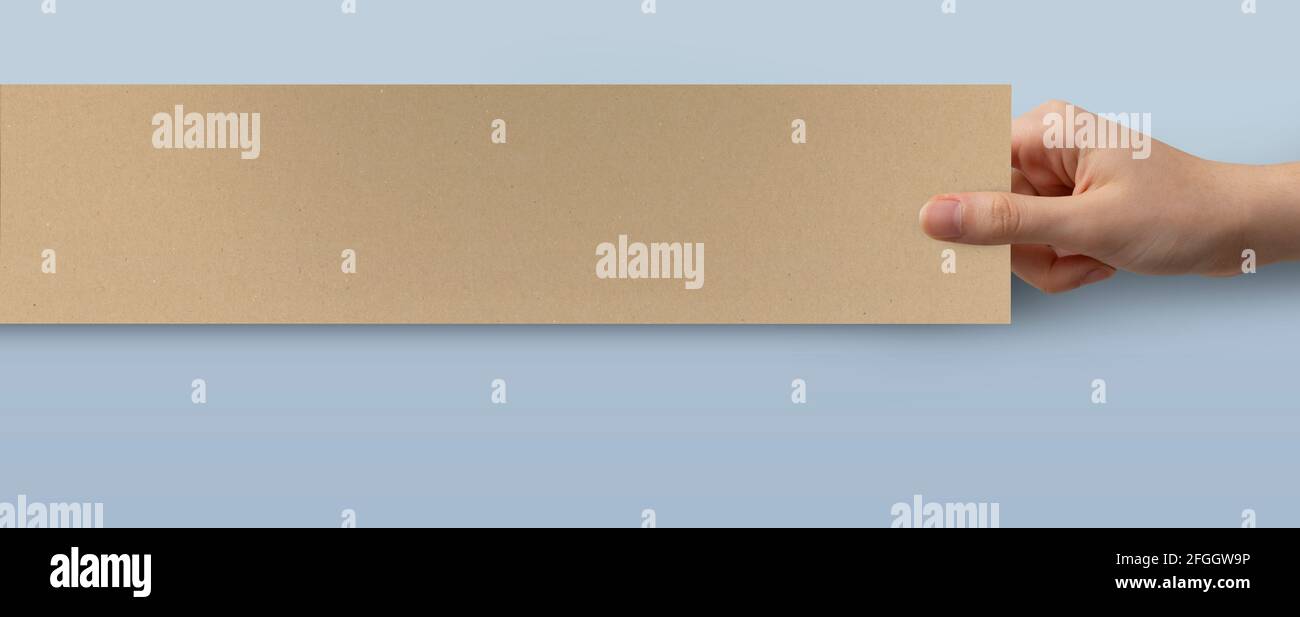 Hand holding craft card on isolated background Stock Photo - Alamy