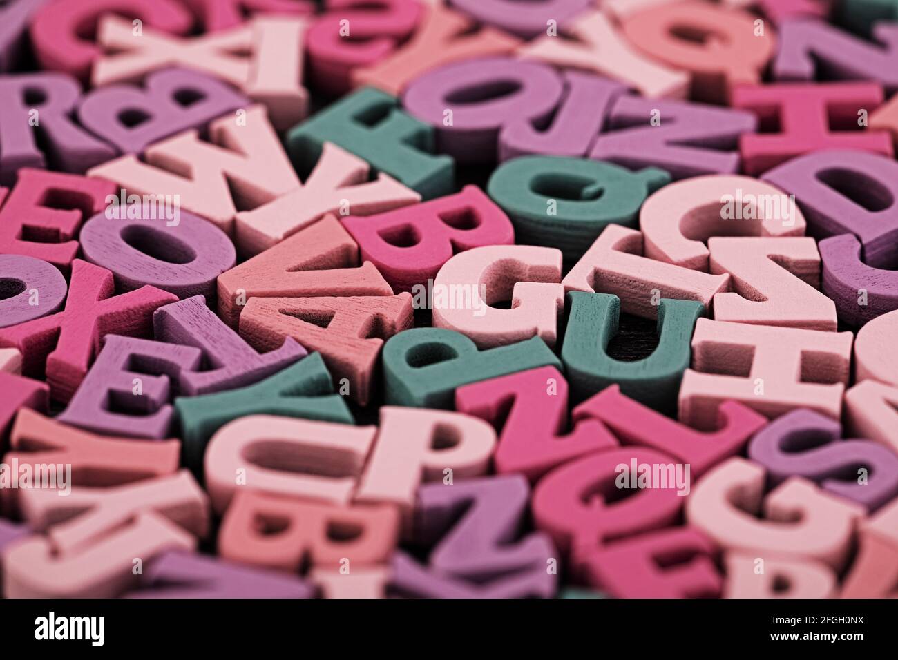 Pile of colorful painted wooden letters. Typography background ...