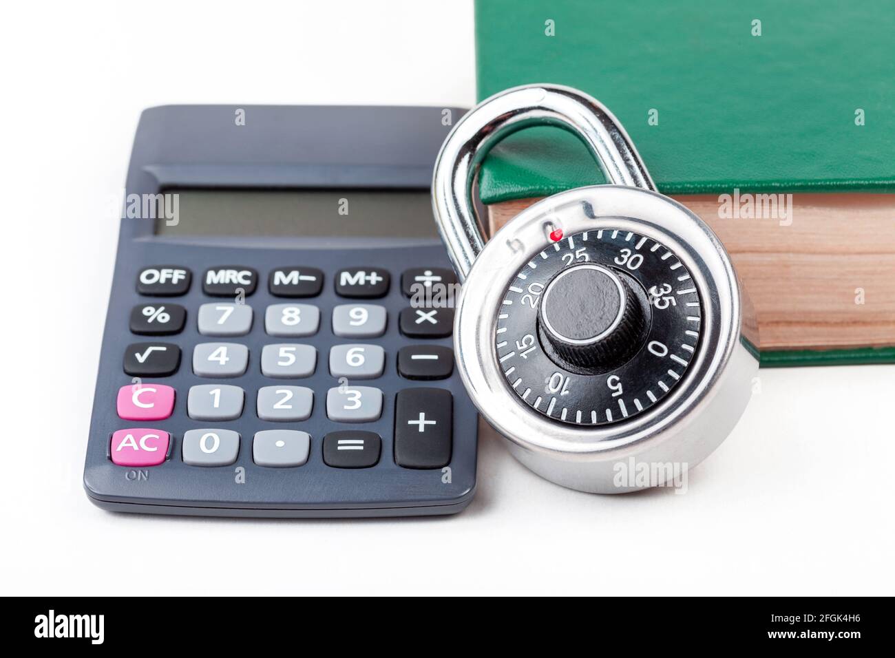 Simple calculator, coded padlock and a closed book, math textbook on ...