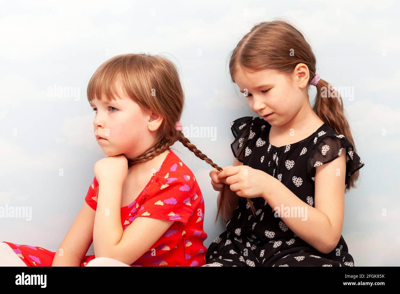 Two little school age children, sisters, siblings or close friends ...