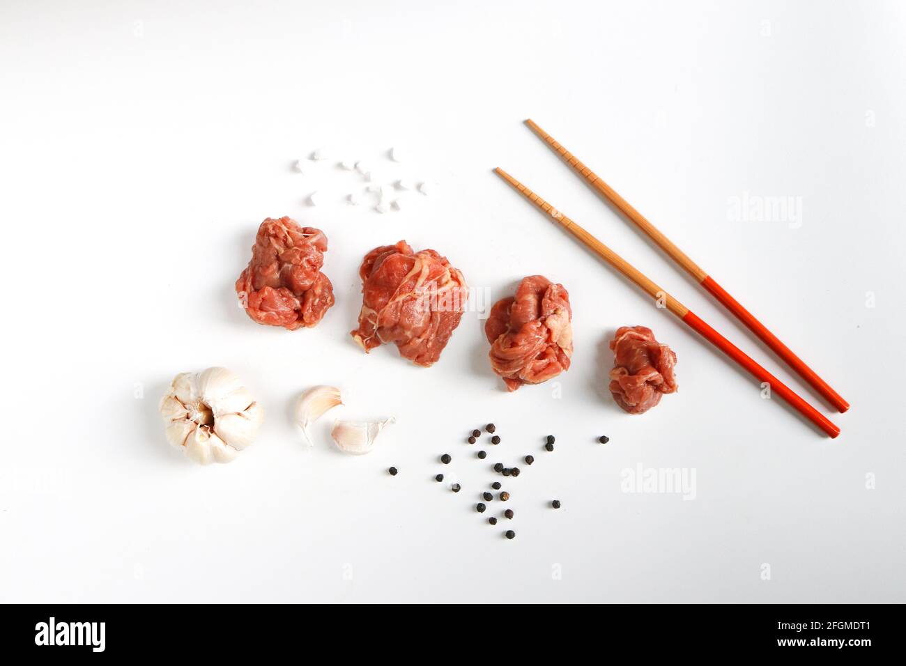 Raw meat in flat lay style with seasoning and garnish Stock Photo - Alamy