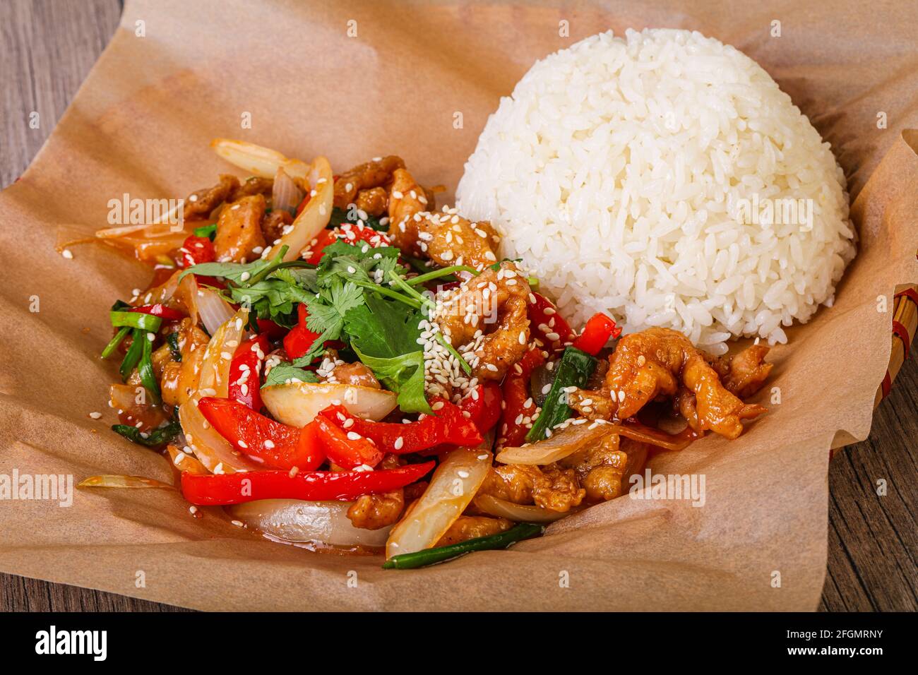 Asian cuisine - chicken with vegetables served rice Stock Photo - Alamy
