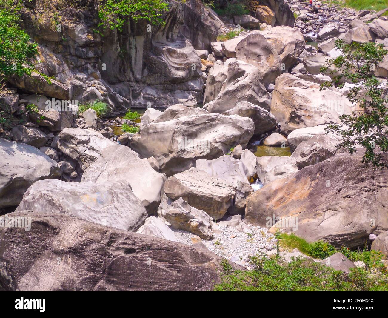 A beautiful view of a valley full of big rocks with greenery Stock ...