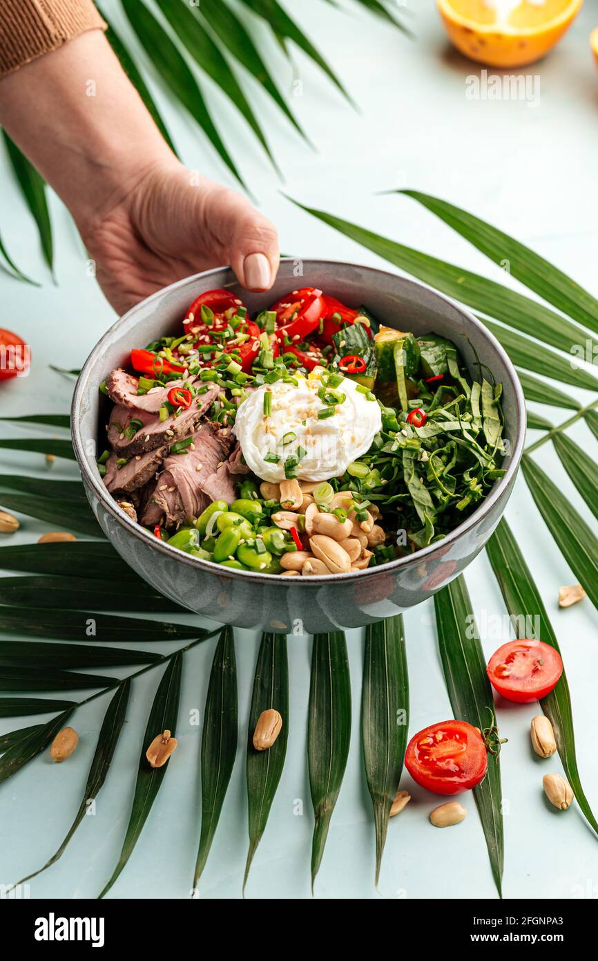 Roast beef pokeh with poached egg and vegetables Stock Photo - Alamy