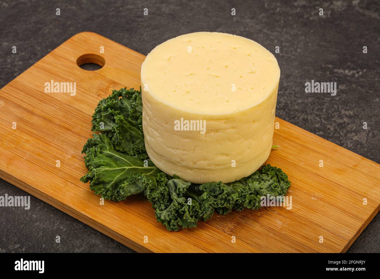 Yellow round dairy soft cheese piece Stock Photo - Alamy