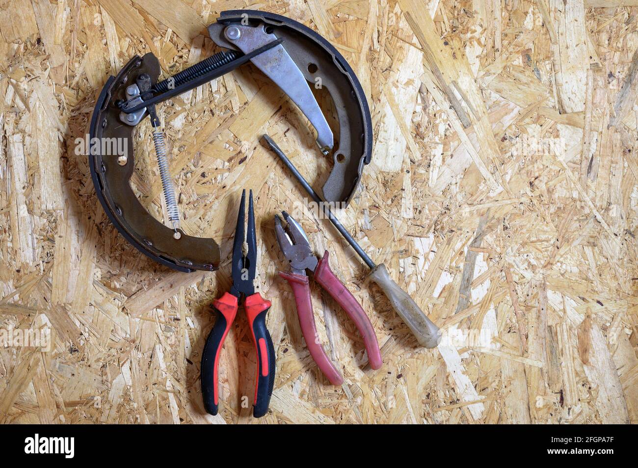 car drum brake disassembled and a set of various repair hand tools or ...