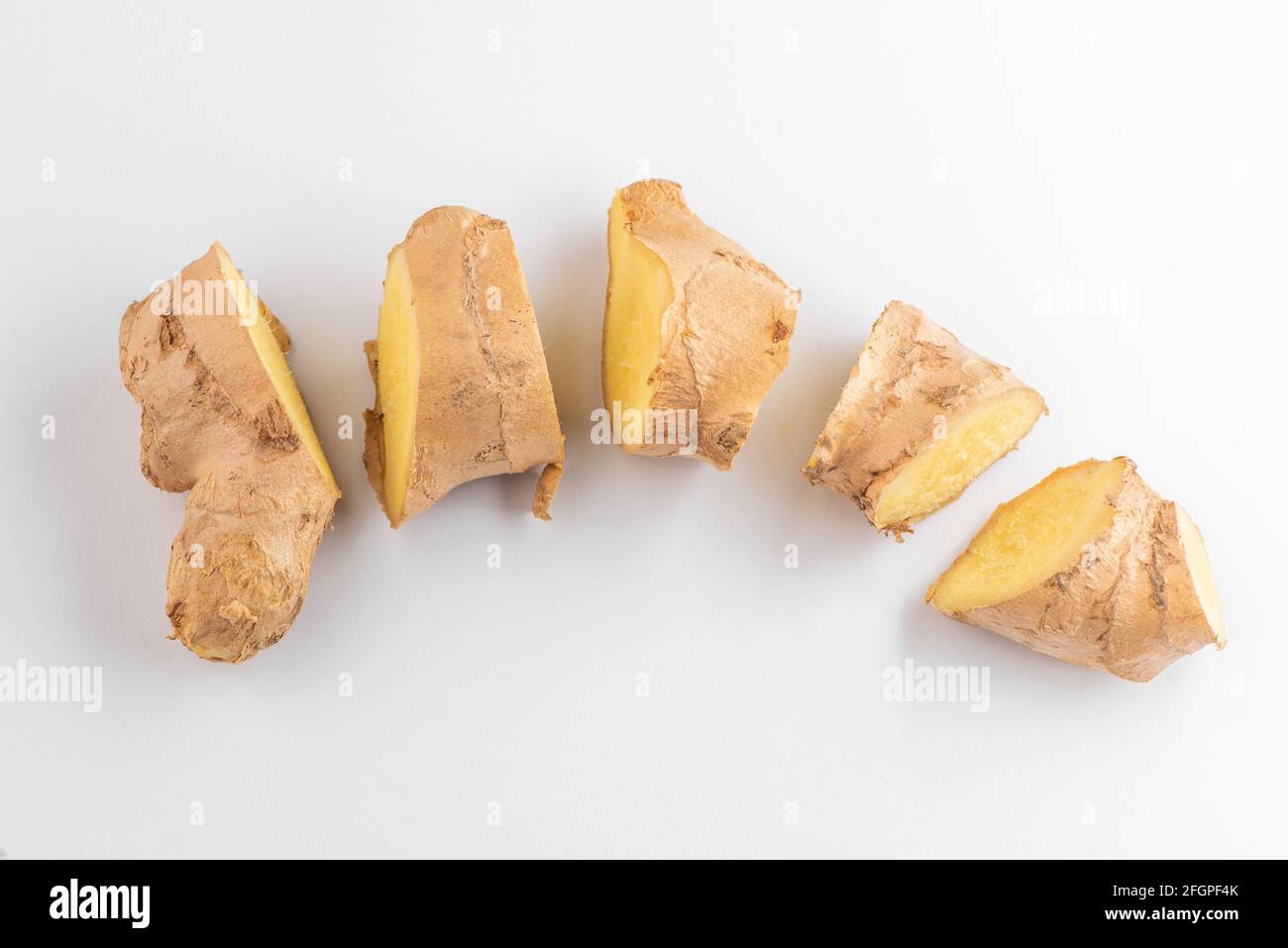 Top view on a freshly cut ginger root on white background Stock Photo ...