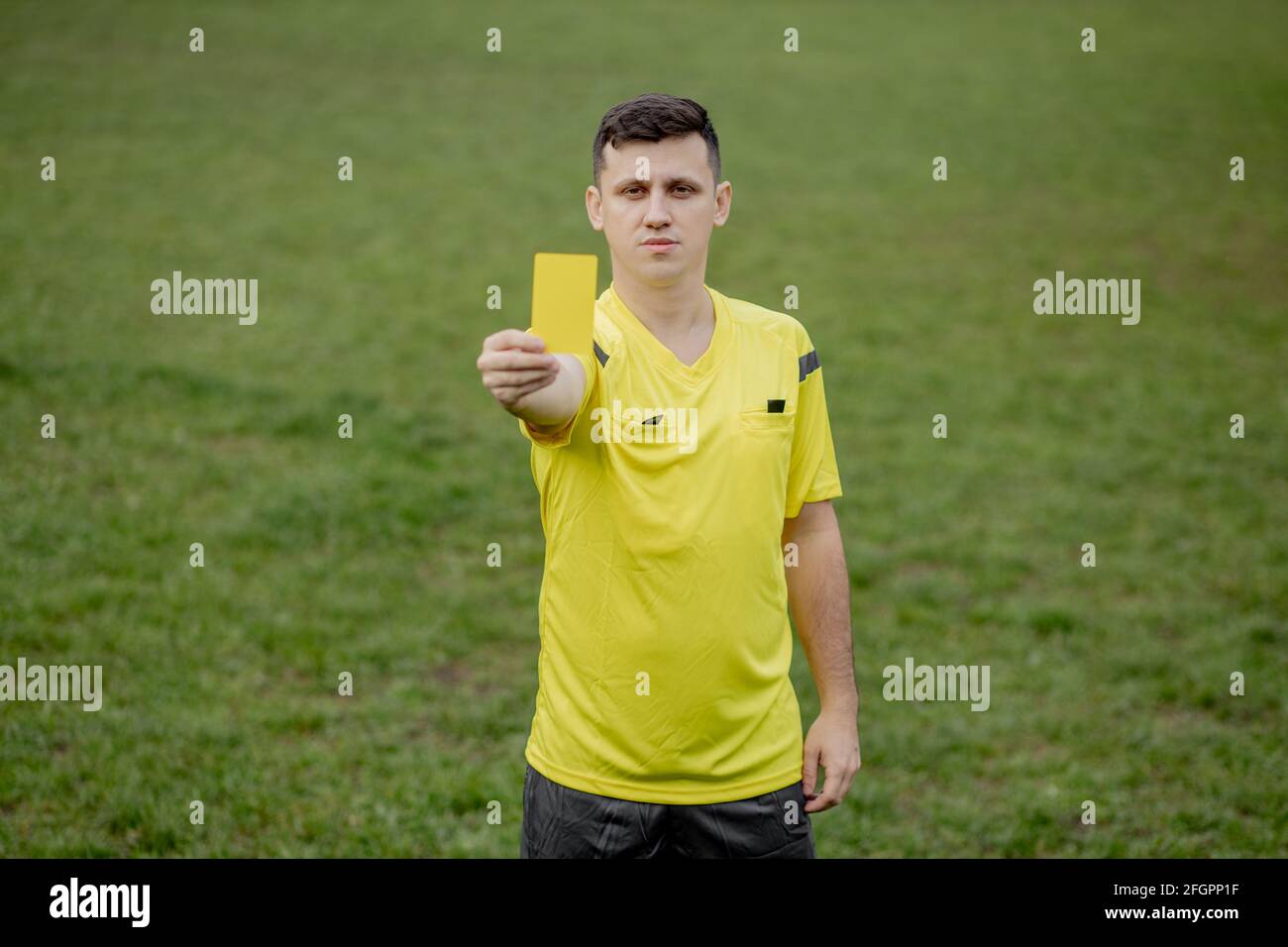 Soccer referee to point out a yellow card to a player in the soccer ...