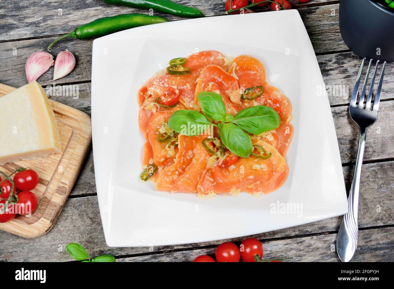 Close up of plate with red heart ravioli with cherry tomato, mozzarella ...
