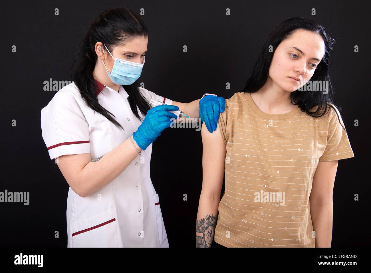 the doctor is vaccinating against the corona virus, to prevent the ...