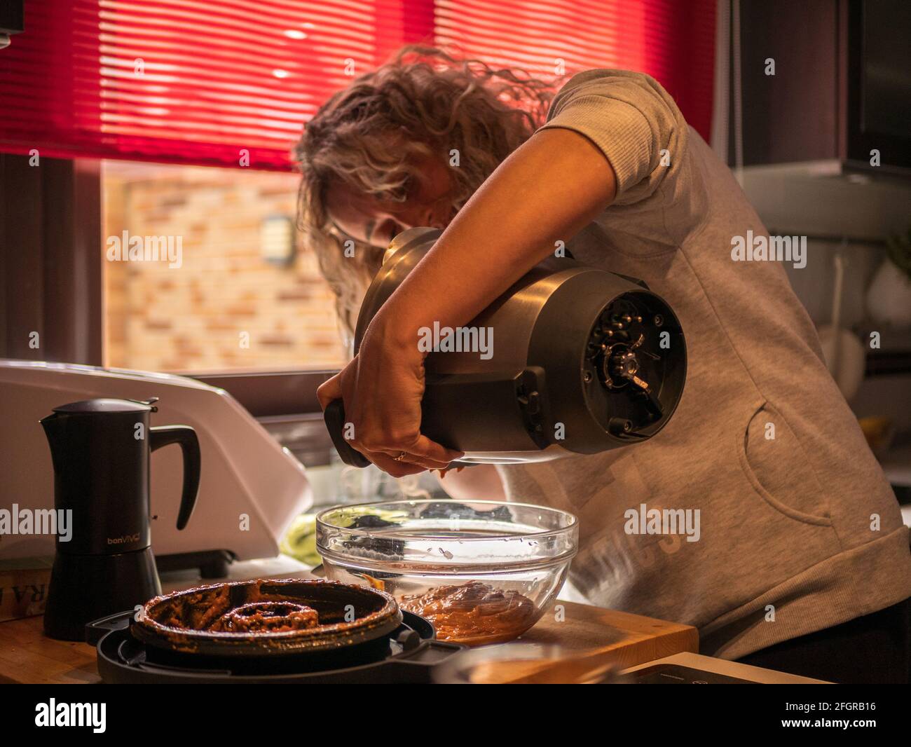 Beautiful Spanish female cooking in her kitchen Stock Photo - Alamy