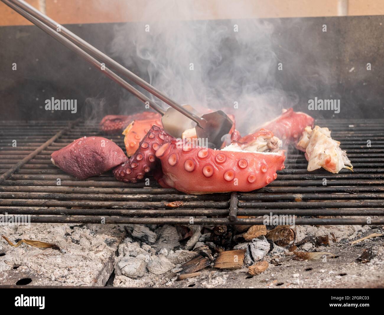Tasty octopus barbecue on a grill Stock Photo - Alamy