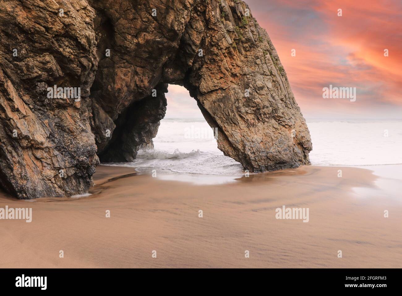 Beautiful stone natural arche at the sunset. Rock formation in a beach ...