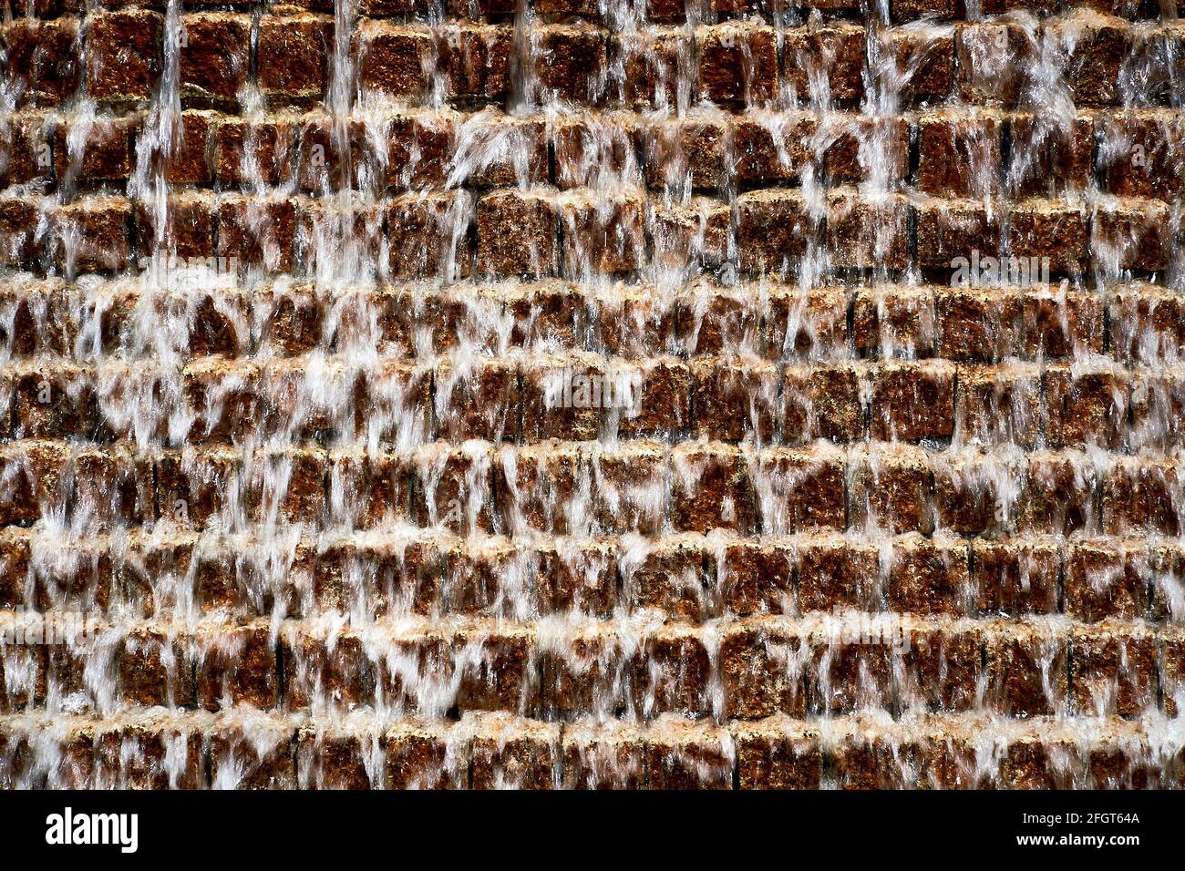 Brown and white background texture of water flows on top of the bricks ...