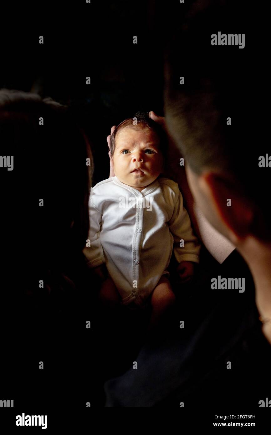 Young father and mother holding their newborn baby son. Mom, dad and ...