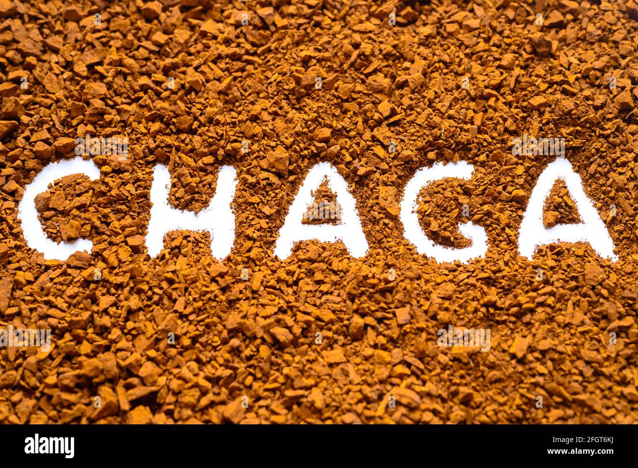 chaga mushroom. handwritten text chaga in a background of a pile of ...