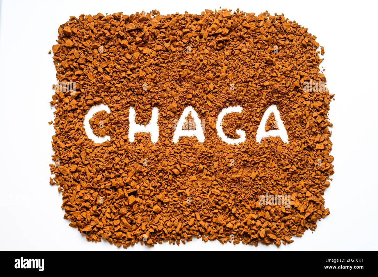 chaga mushroom. handwritten text chaga in a pile of small fragments of ...