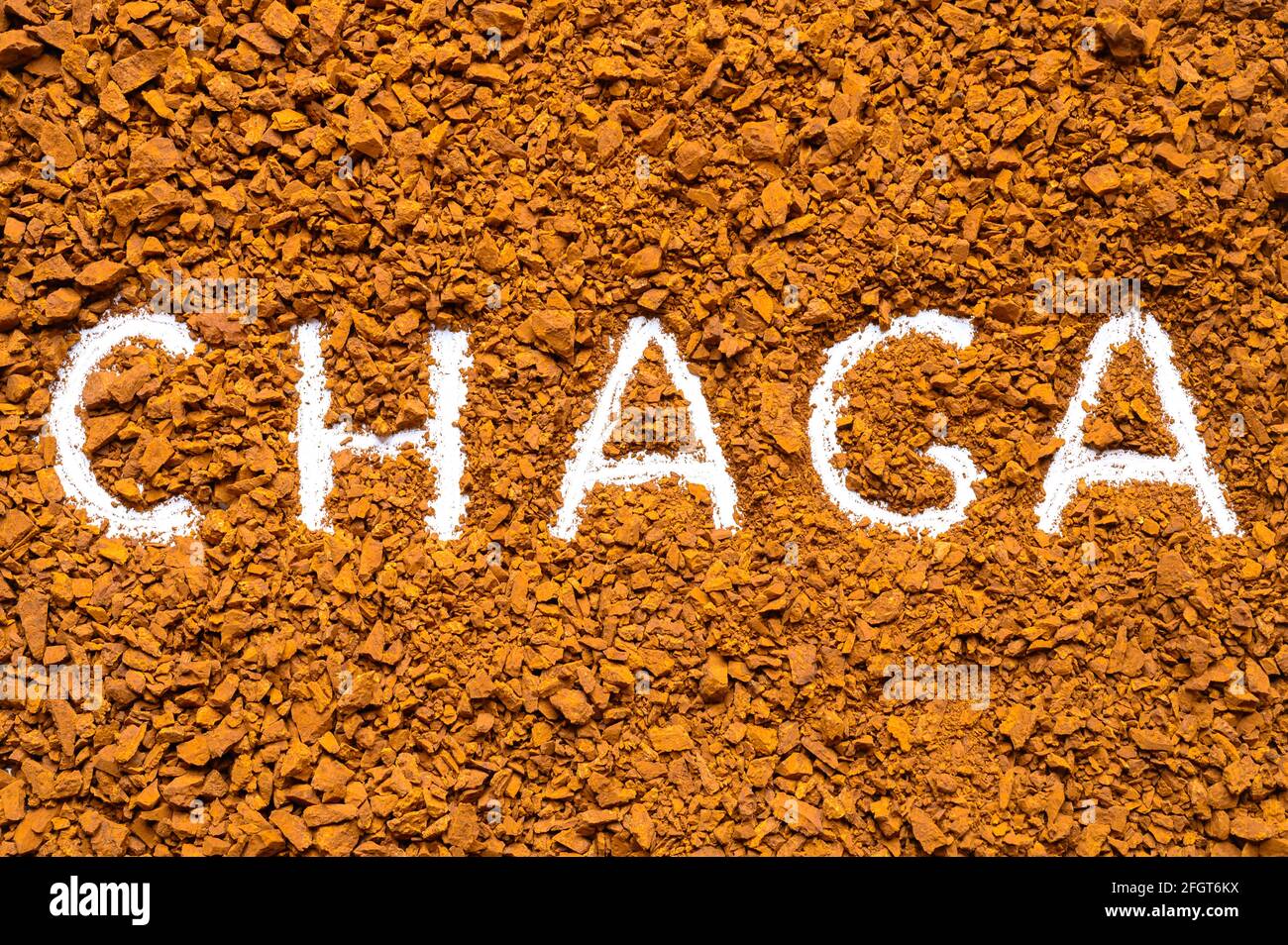 chaga mushroom. handwritten text chaga in a background of a pile of ...