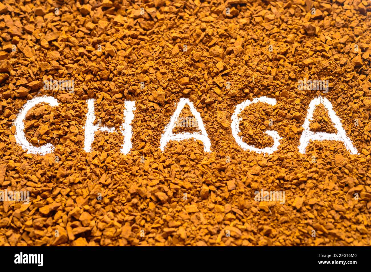 chaga mushroom. handwritten text chaga in a background of a pile of ...