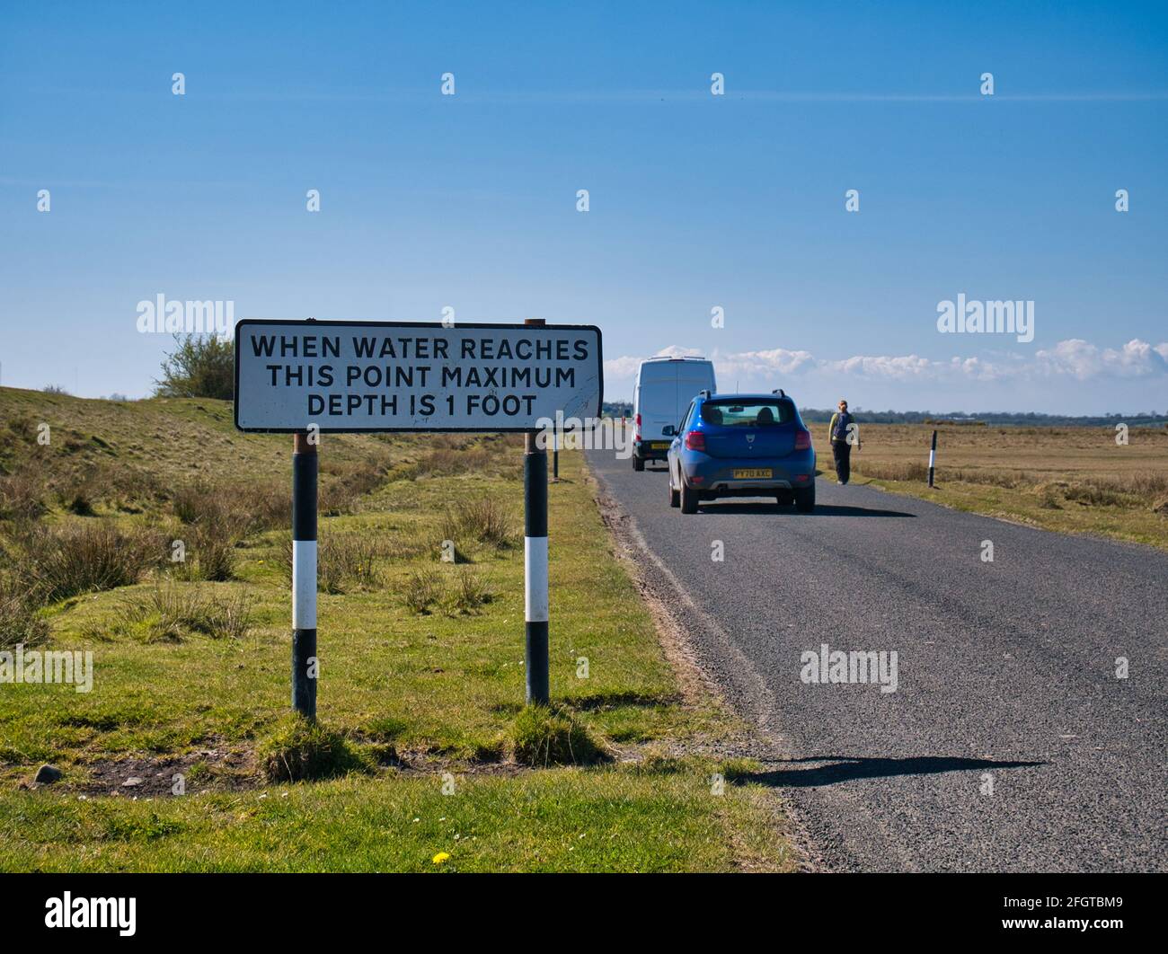 A roadside sign warns that when water reaches the sign that the depth ...