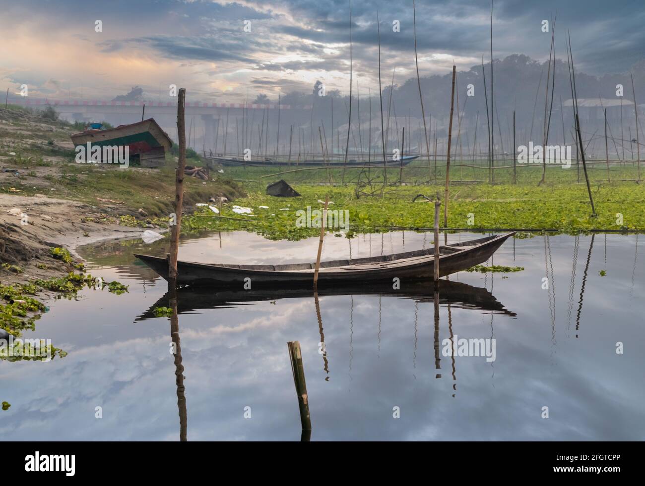 A small boat or dingi is anchored in river Stock Photo - Alamy