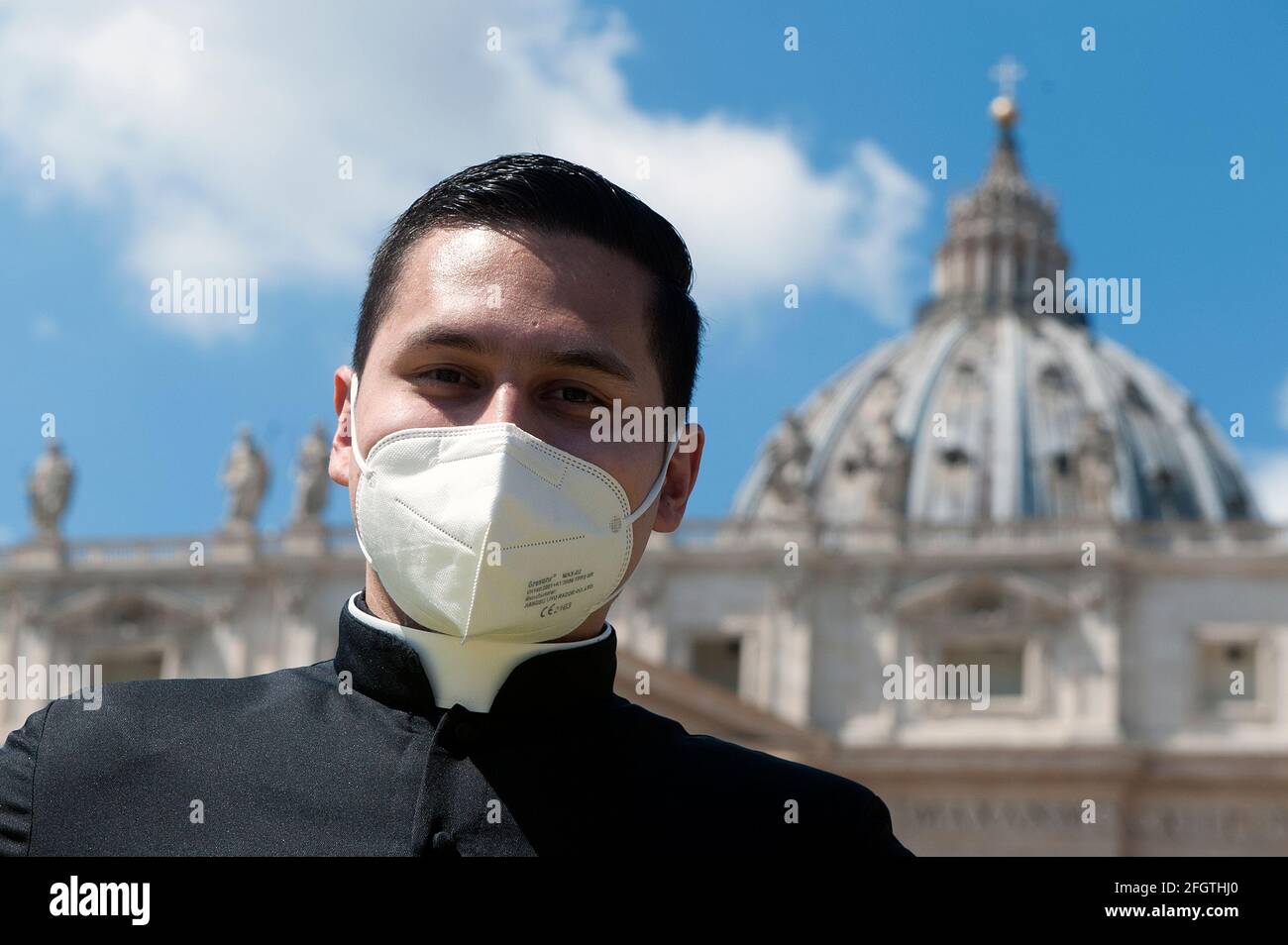 Rome, Italy. 25th Apr, 2021. A priest wearing a face mask and holding ...