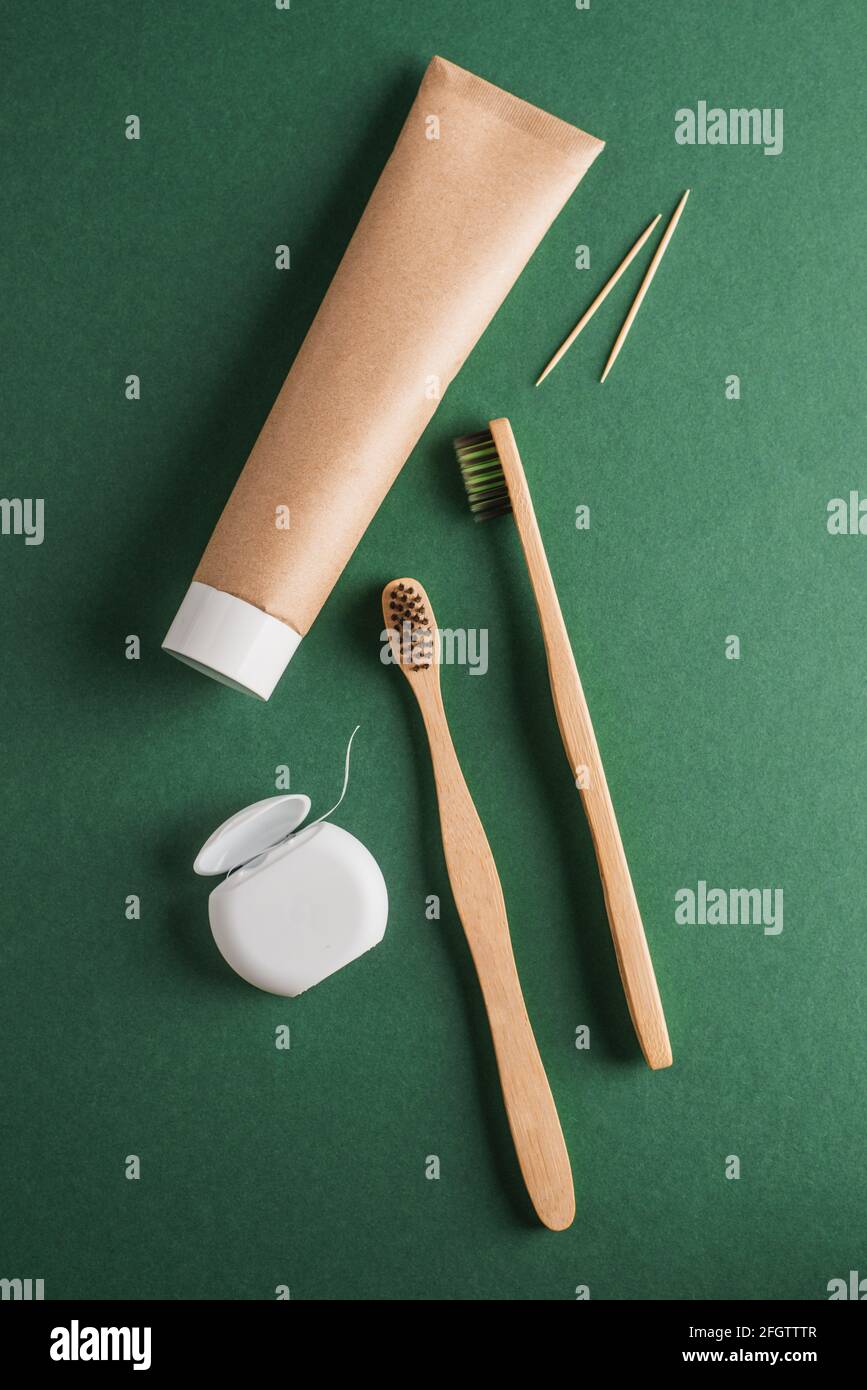 Top view on set of dental floss, toothpaste, wooden toothbrushes and ...