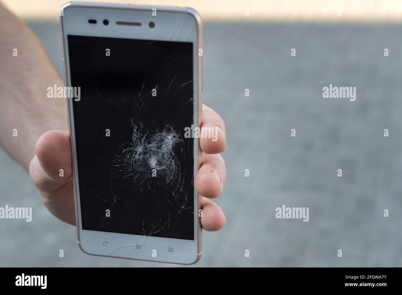 Man holds a smartphone with a broken screen. Concept phone repair Stock ...