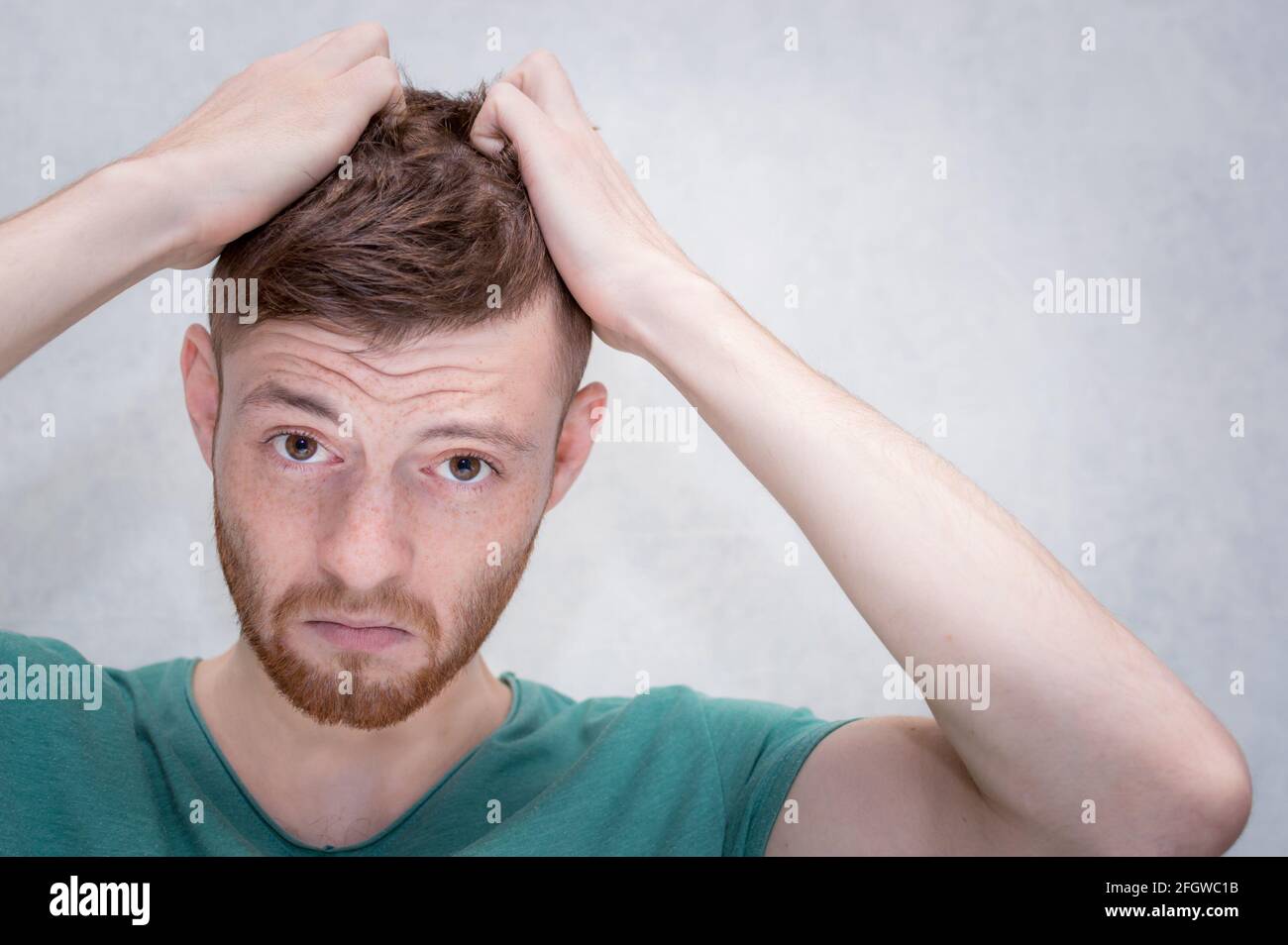 Young man tears hair on his head from annoyance. Closeup portrait Stock ...