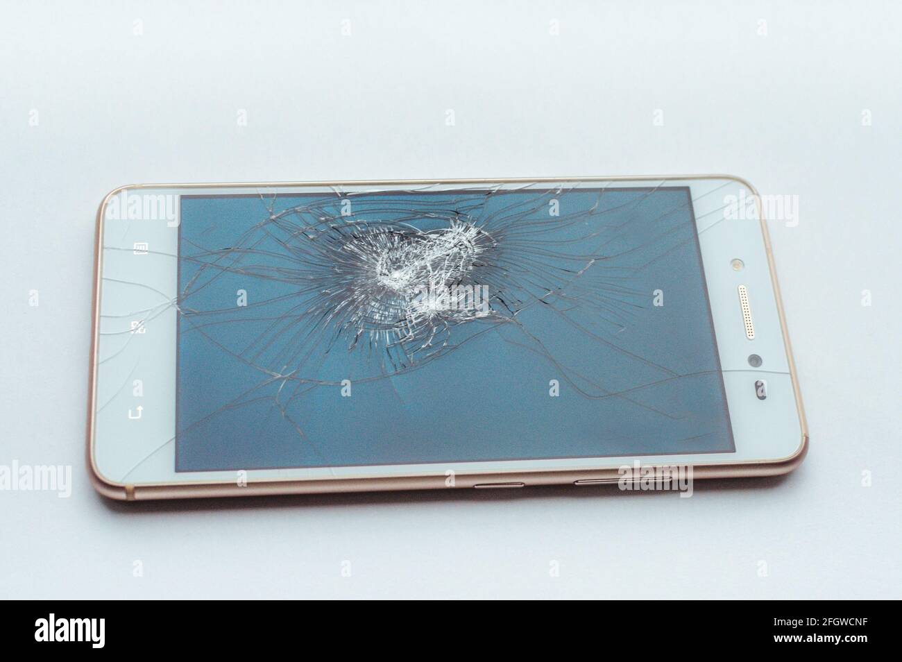 Mobile phone with broken glass close-up on a white background Stock ...