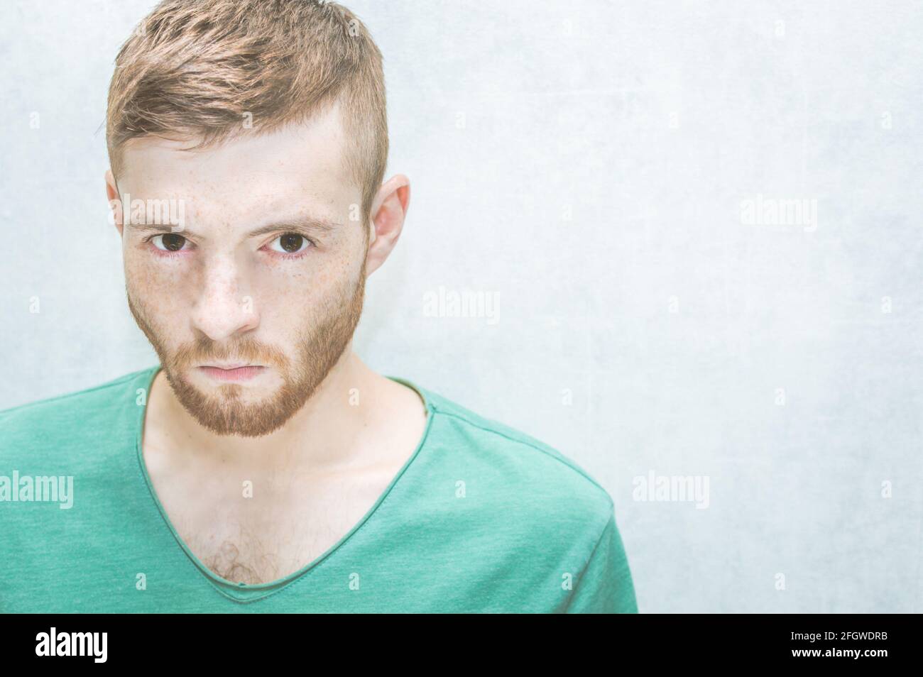 Portrait of a young man with an evil expression. Concept of anger and ...