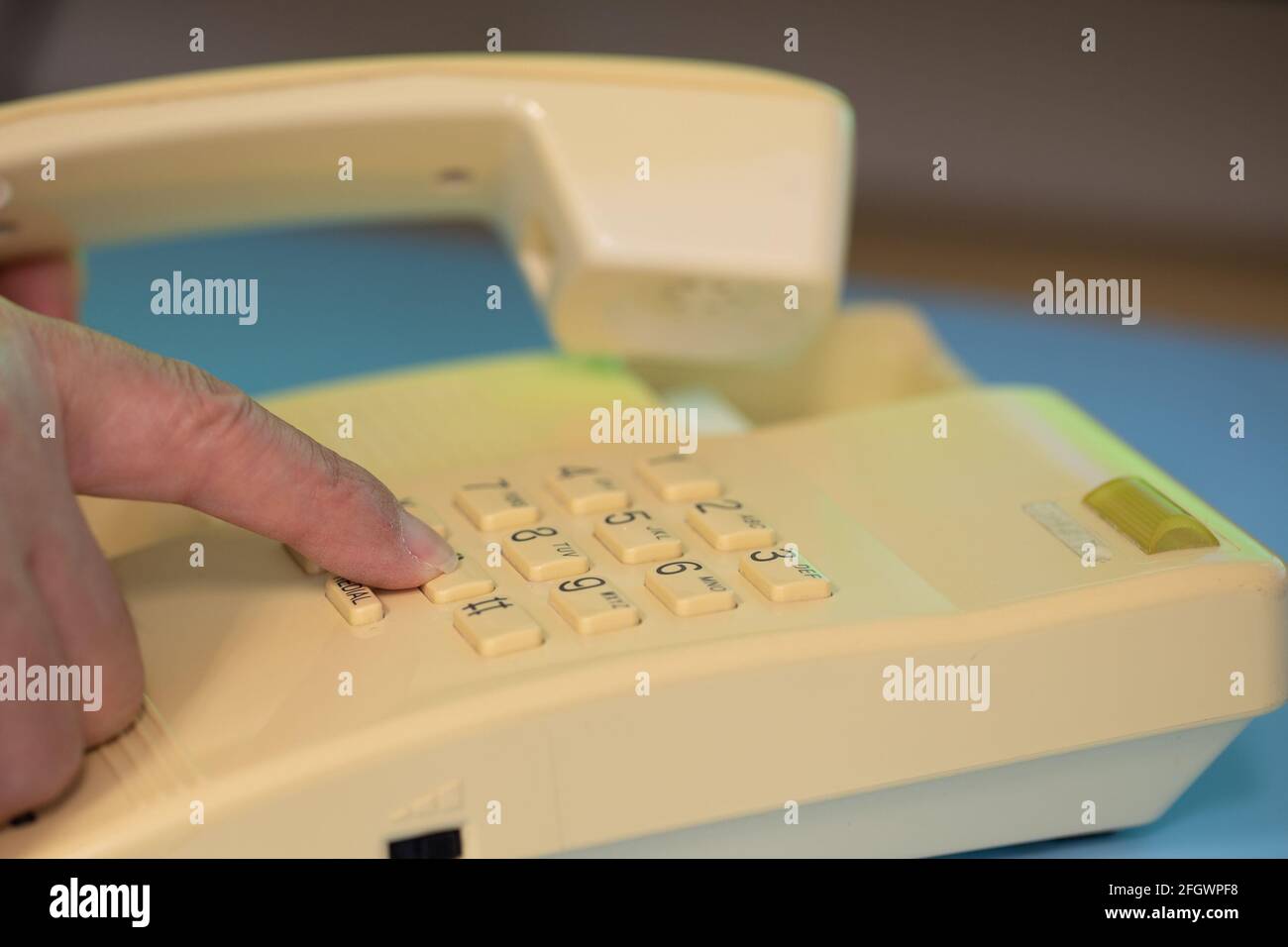 Closeup view of finger dialing telephone number on old style wired ...