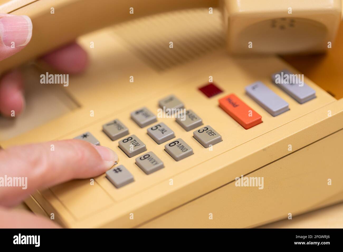 Closeup view of finger dialing telephone number on old style wired ...