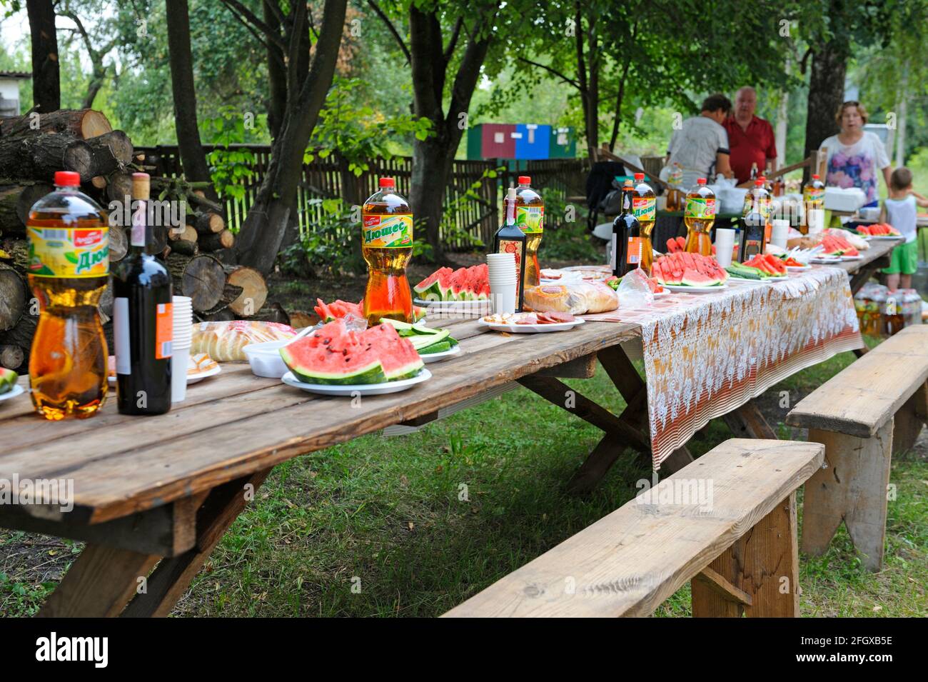 Typical Ukrainian rural celebration. Wooden table set up with bottles ...