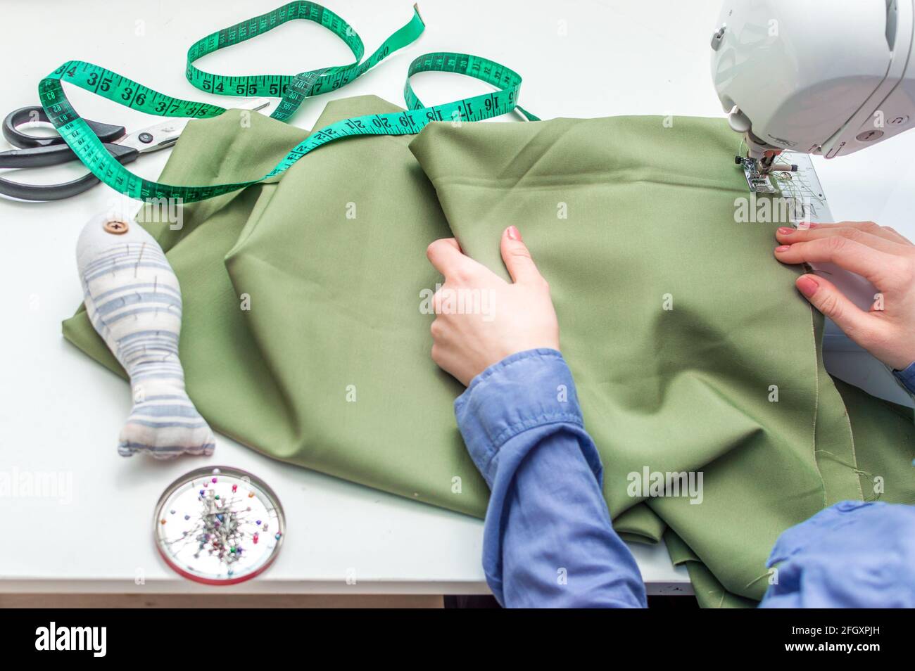 Sewing workshop. A young woman sews on a sewing machine Stock Photo - Alamy
