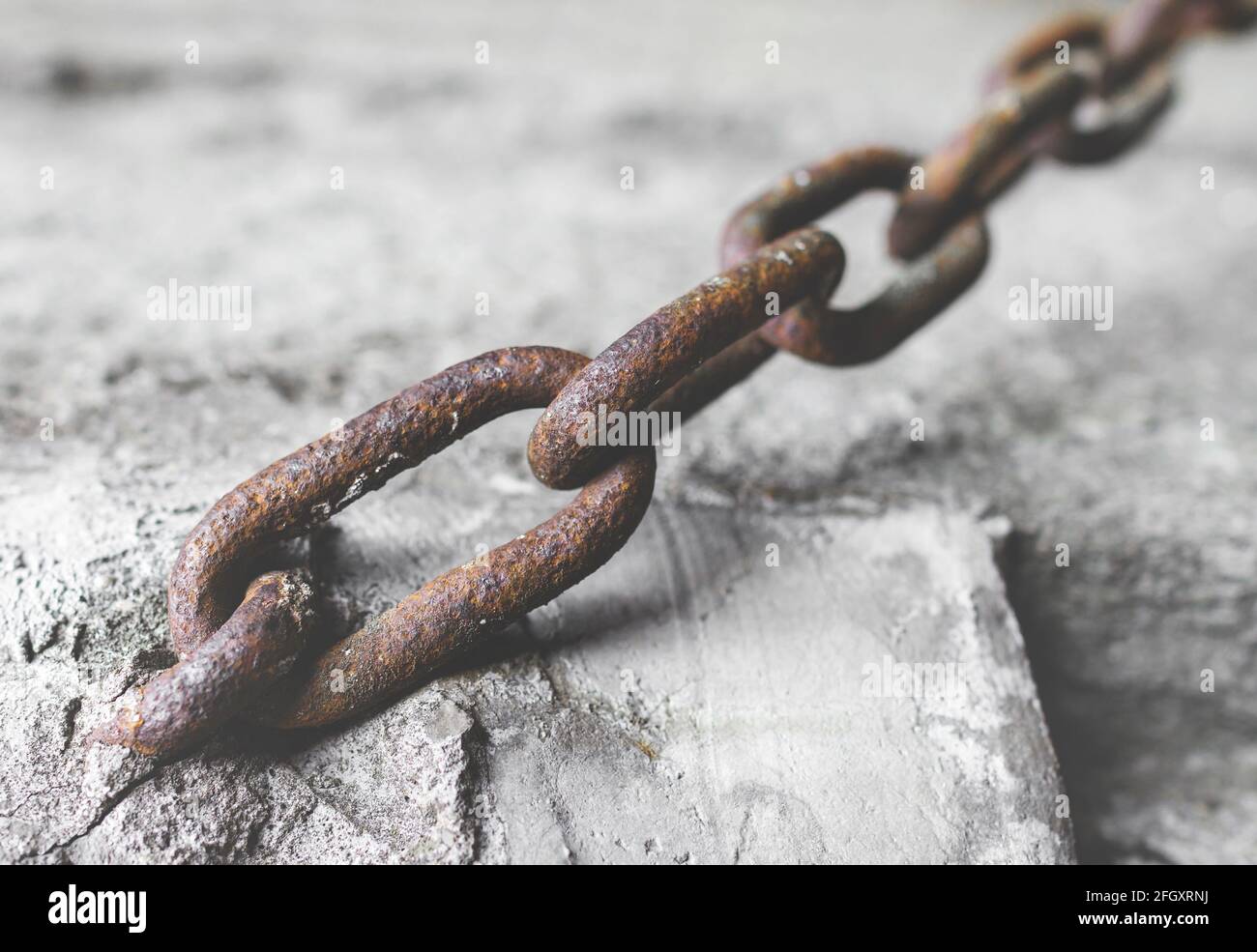 Rusty chain in the cement. Retro style photo. Shallow DOF Stock Photo ...