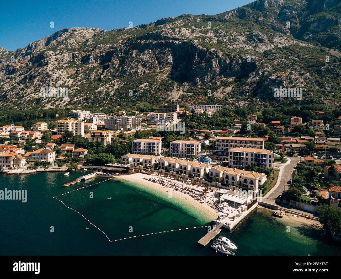 View of the beach in Dobrota, Montenegro against the backdrop of ...