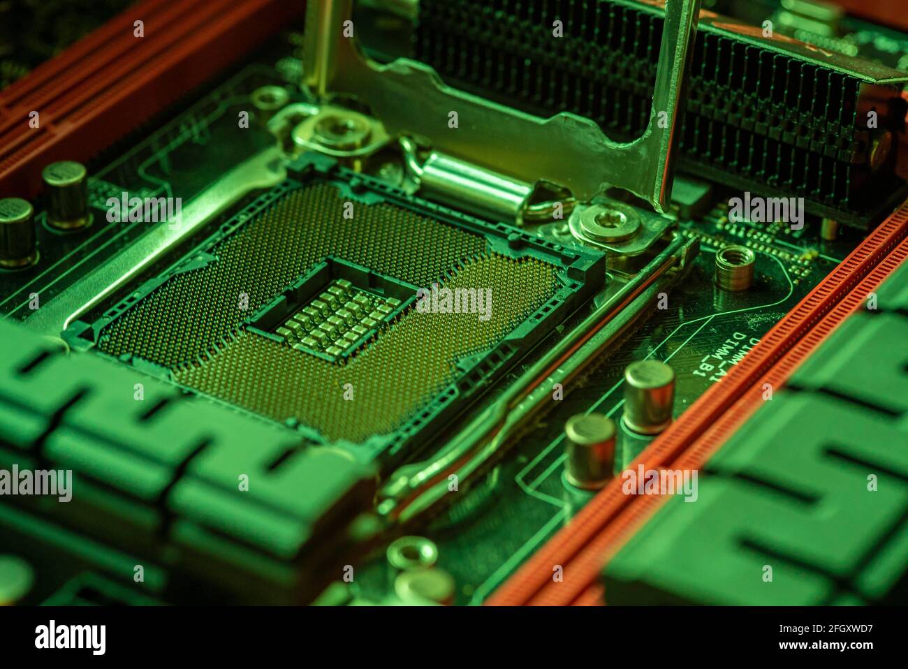 Detail of a Cpu socket in a motherboard of a gaming pc in green light ...