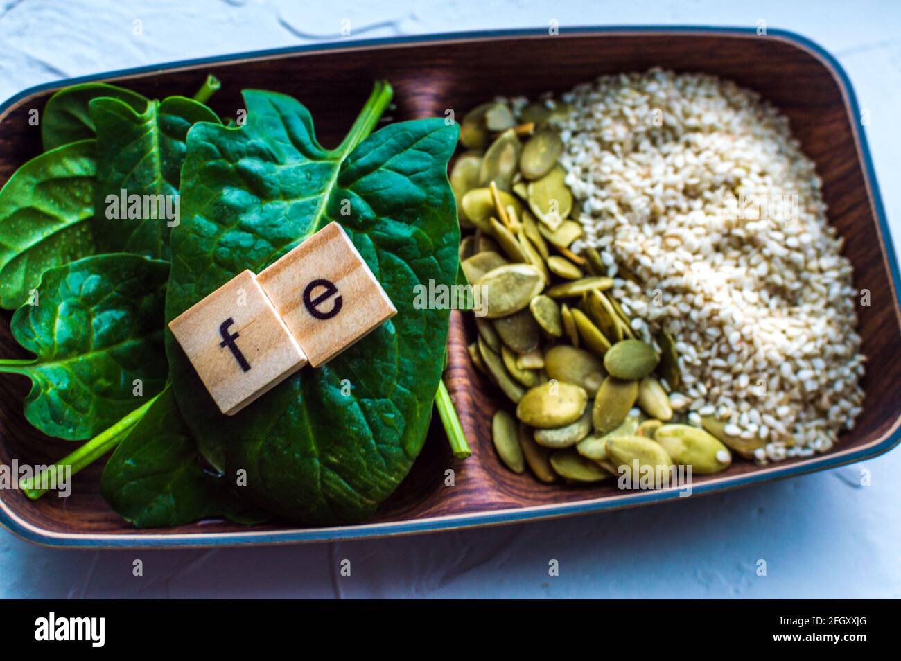 Spinach, pumpkin seeds, sesame on a white background. microelement FE ...