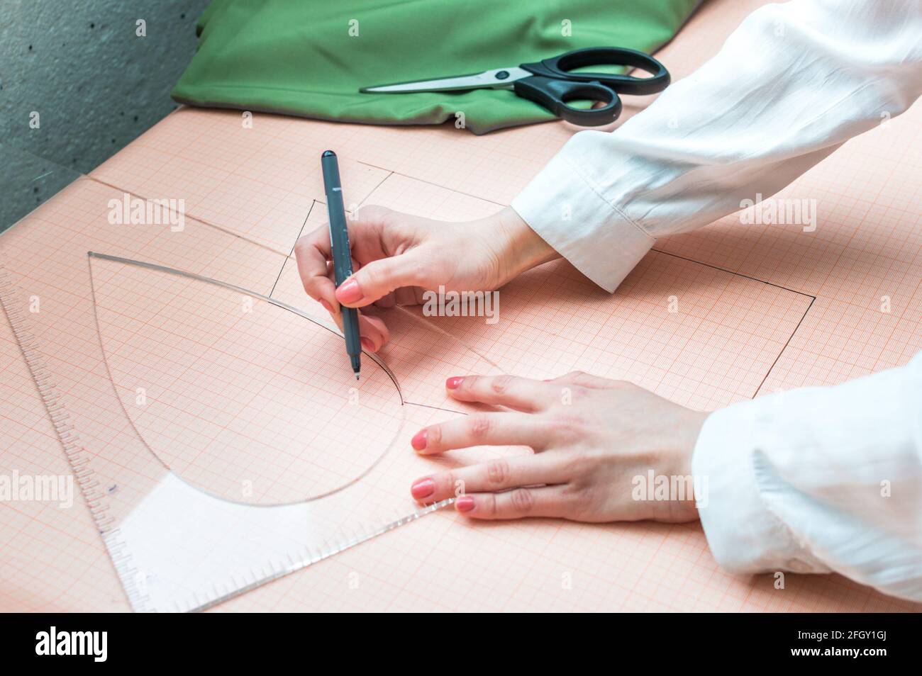 Seamstress hands close up designing clothes Stock Photo - Alamy