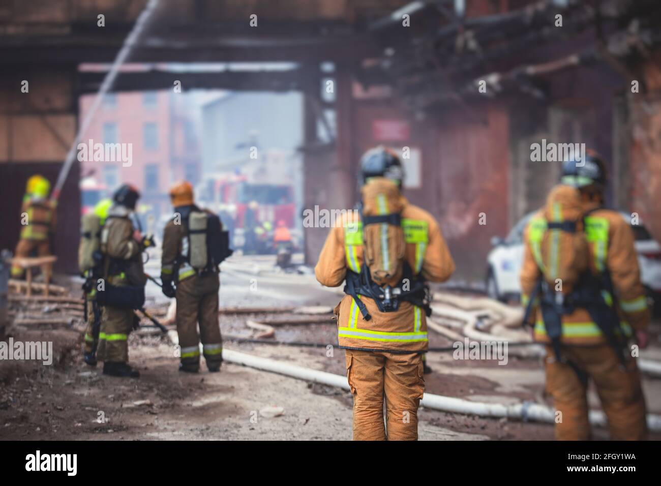Firefighters put out large massive fire blaze, group of fire men in ...