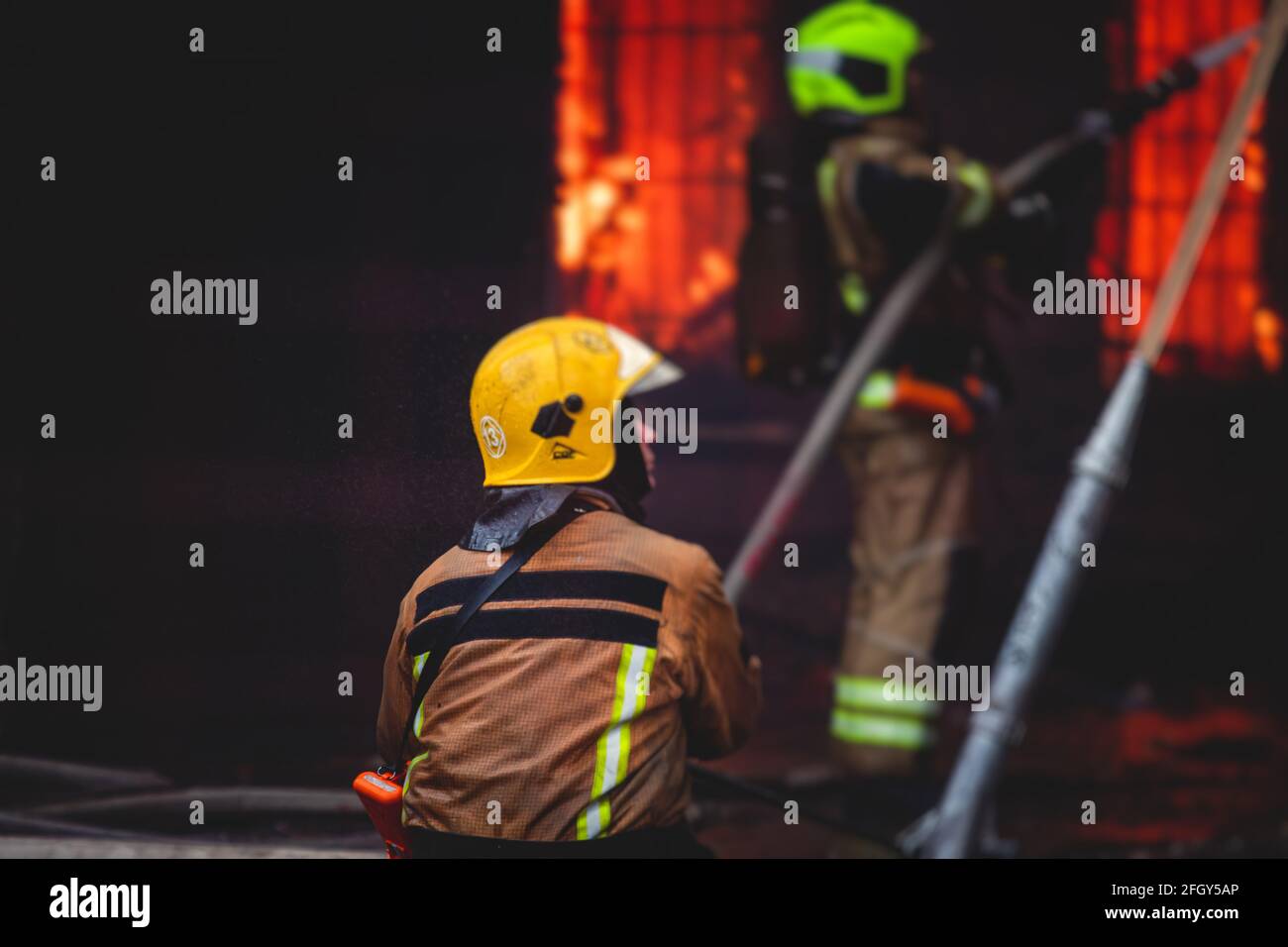 Firefighters put out large massive fire blaze, group of fire men in ...