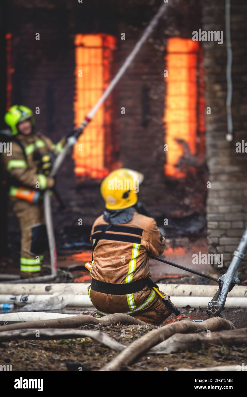 Firefighters put out large massive fire blaze, group of fire men in ...