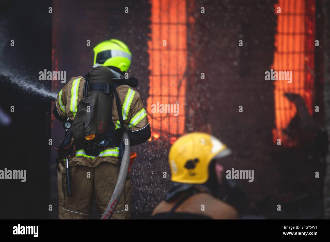 Firefighters put out large massive fire blaze, group of fire men in ...