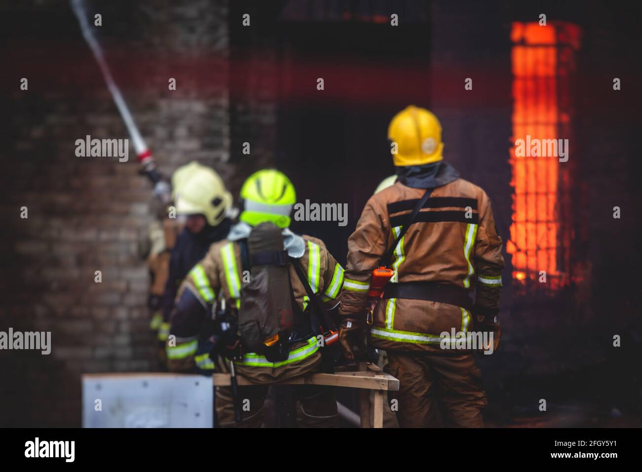 Firefighters put out large massive fire blaze, group of fire men in ...