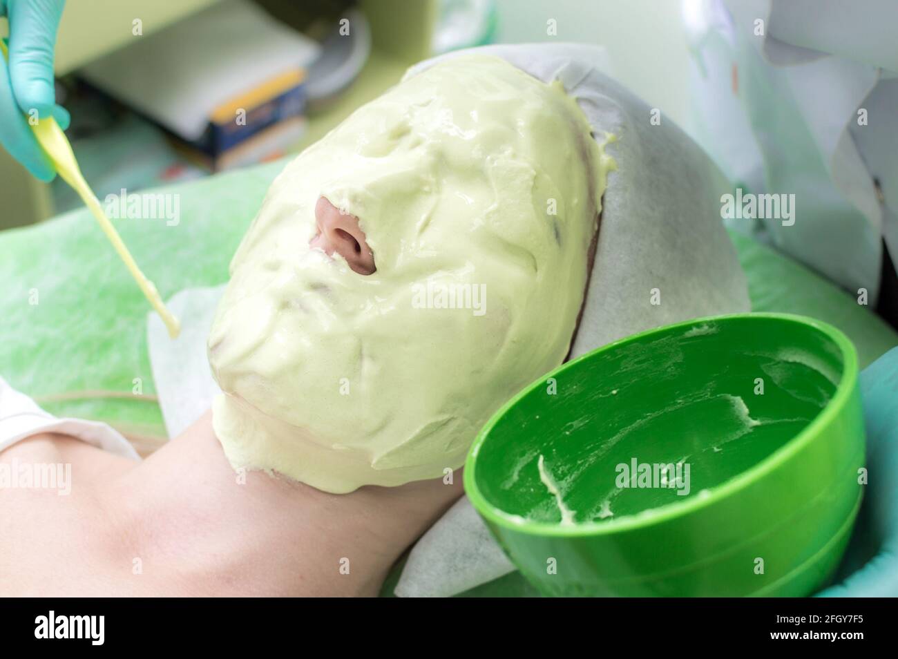 Beautician Applying Alginate Mask On Female Face Stock Photo - Alamy